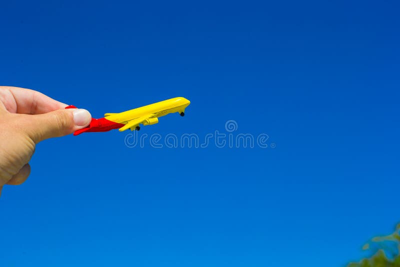 Small Plane in Female Hand on Background of Blue Stock Photo - Image of ...