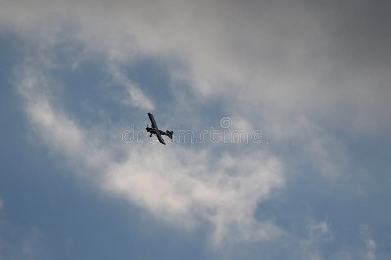 Small Plane Flying in the Sky Against Dark Clouds Stock Image - Image ...