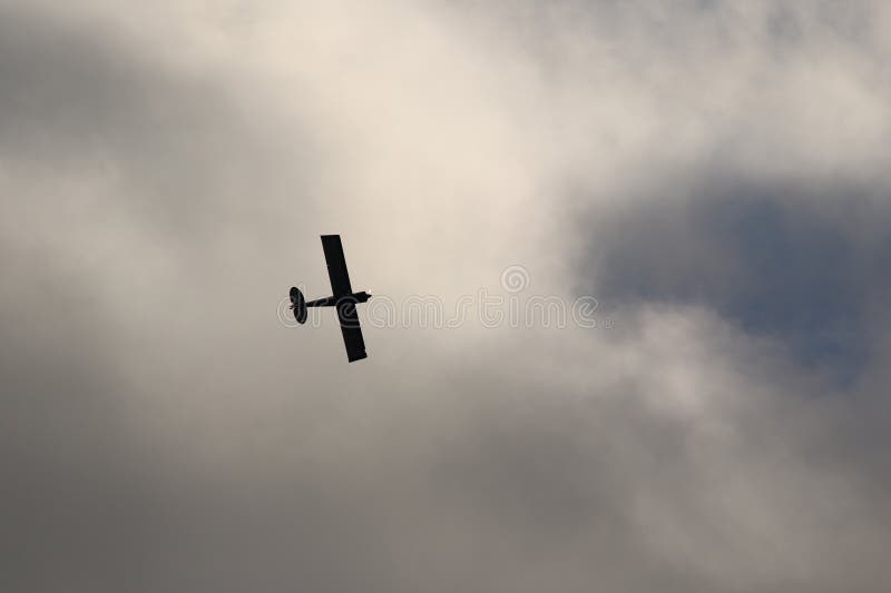 Small Plane Flying in the Sky Against Dark Clouds Stock Image - Image ...