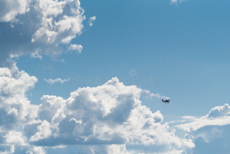A Small Plane in Front of Giant Clouds after the Storm. the Clouds ...