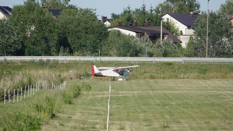 A Small Plane Landing in a Small Meadow Stock Photo - Image of light ...