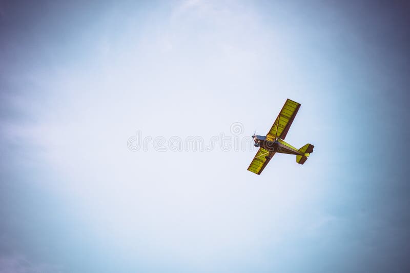 Small Plane in the Sky and on the Field Stock Photo - Image of trails ...