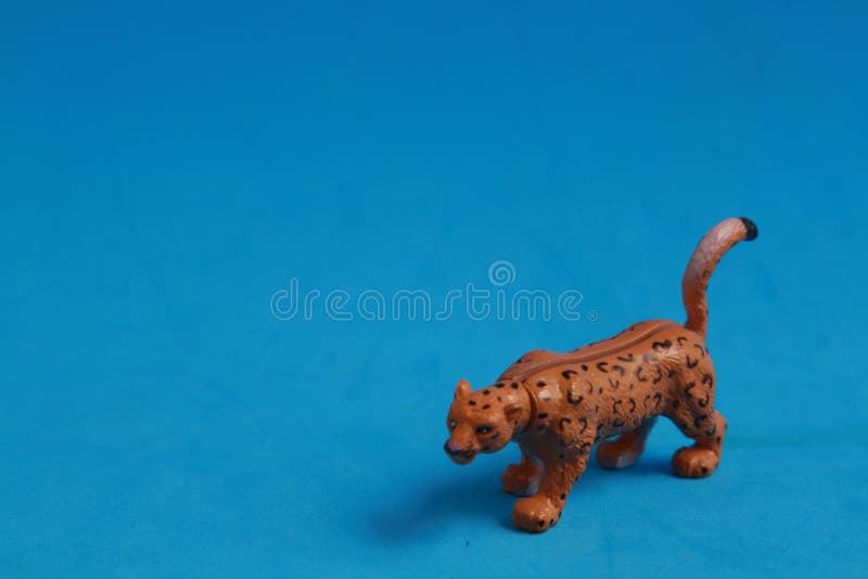 Small Plastic Leopard Toy Isolated on a Blue Background Stock Image ...