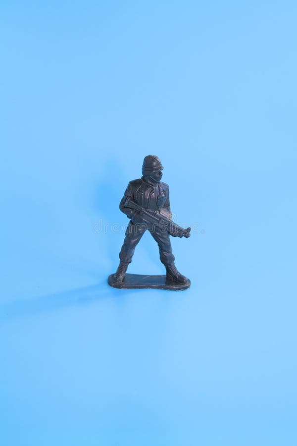 Small Plastic Soldiers Standing on a Blue Background Stock Photo ...