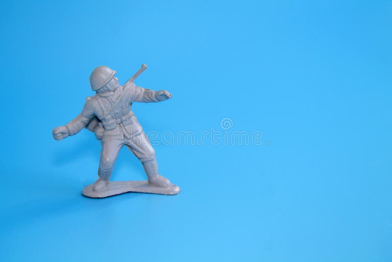 Small Plastic Soldiers Standing on a Blue Background Stock Photo ...