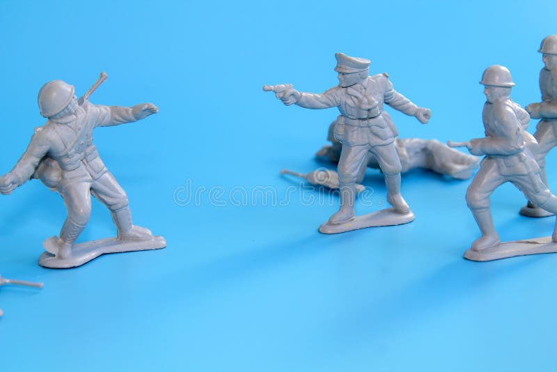 Small Plastic Soldiers Standing on a Blue Background Stock Photo ...
