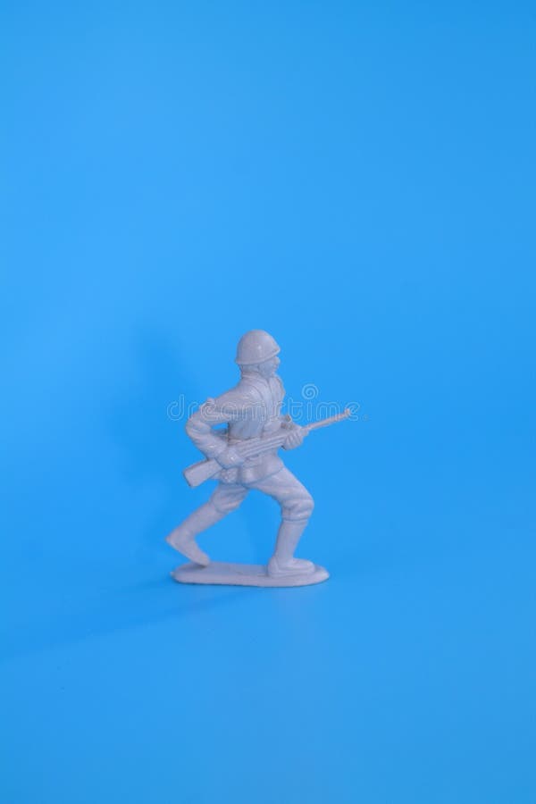 Small Plastic Soldiers Standing on a Blue Background Stock Photo ...