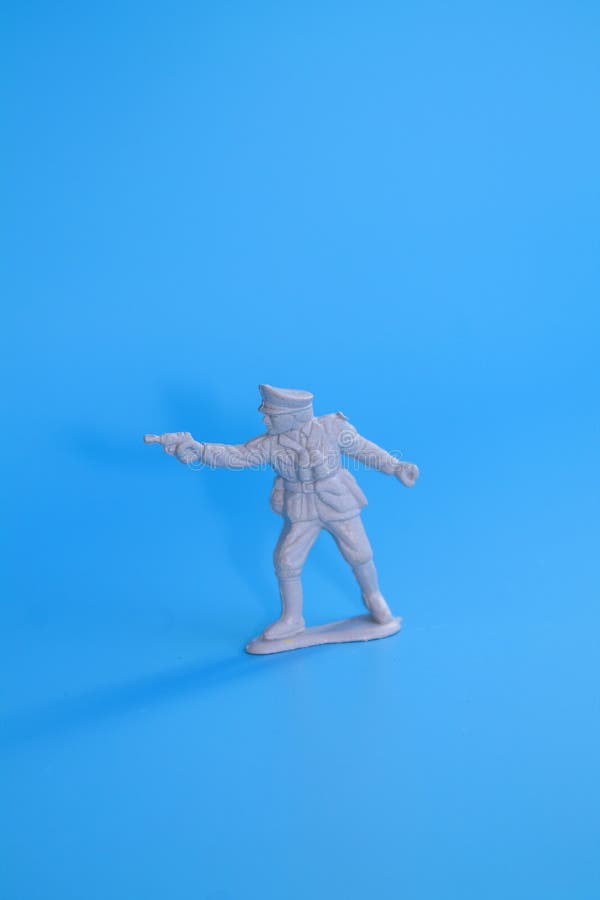Small Plastic Soldiers Standing on a Blue Background Stock Photo ...
