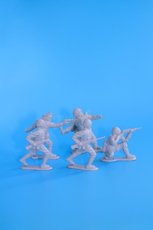 Small Plastic Soldiers Standing on a Blue Background Stock Photo ...