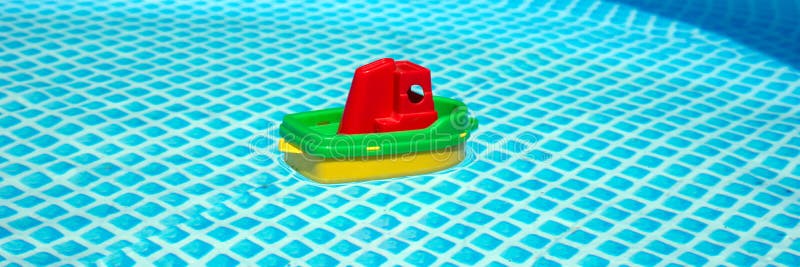 Small Plastic Toy Boat Floating in a Swimming Pool. Panorama Stock ...