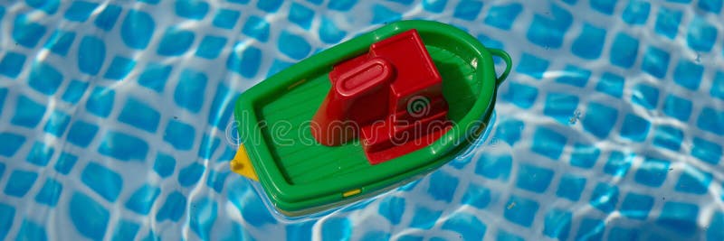 Small Plastic Toy Boat Floating in a Swimming Pool. Panorama Stock ...