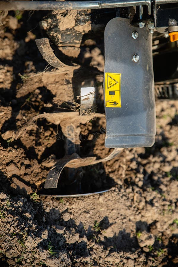 Small Plowing Machine in Hands of a Farmer Making Arable in Black Soil ...