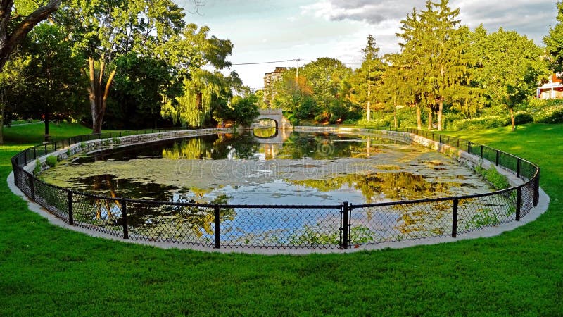 Small Pond Fenced with Small Metal Fences. Stock Image - Image of ...