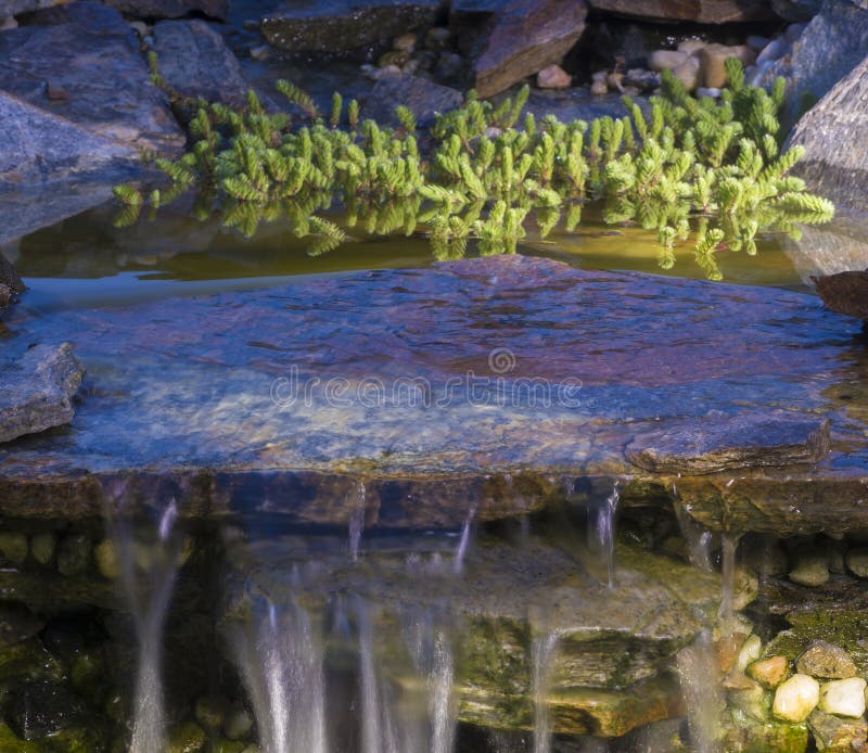 Yard waterfall over a pond stock image. Image of refreshing - 124099527