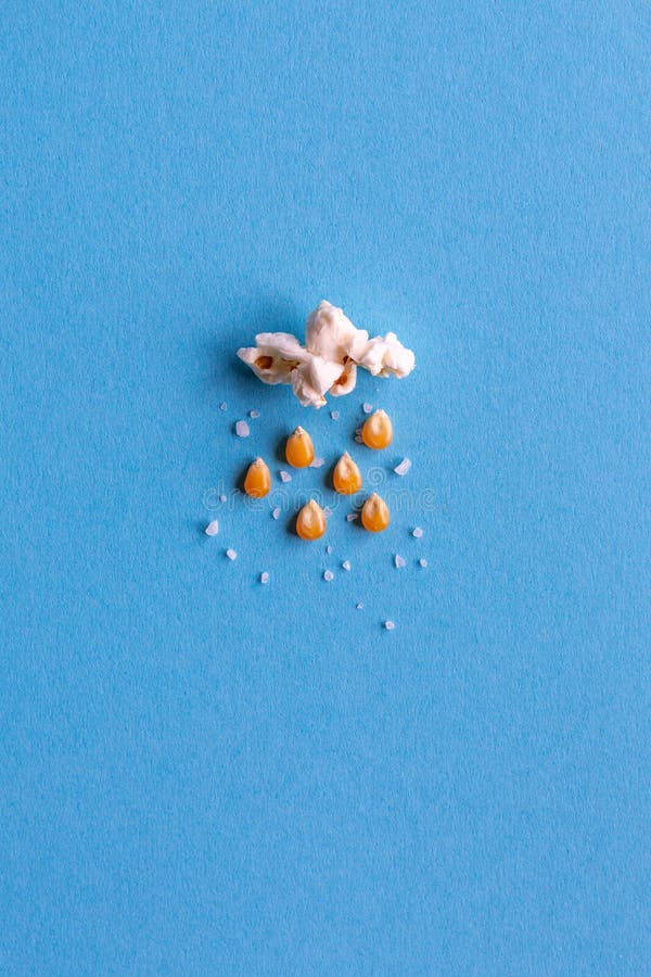 Small Popcorn Cloud with Rain Made Out of Corn Kernels and Salt on Blue ...