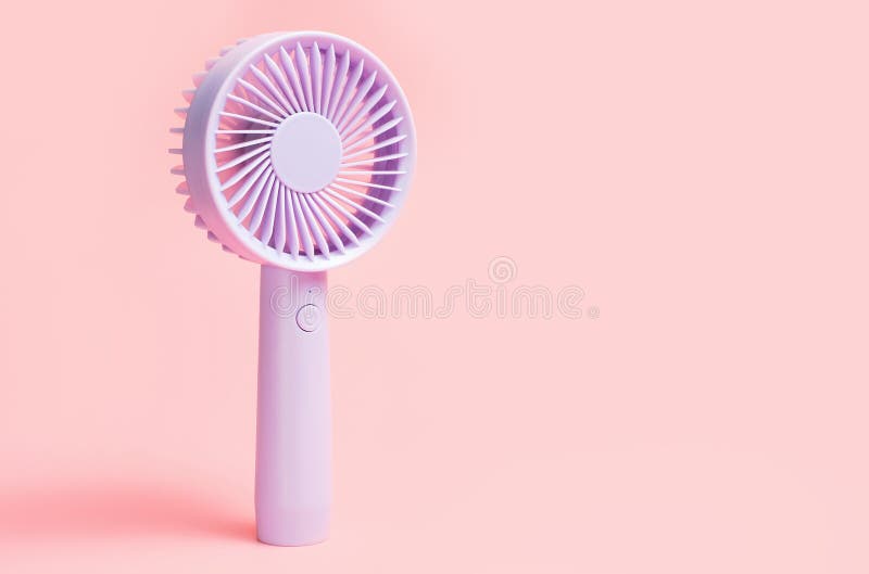 Small Portable Fan on Pink Background Close-up, Front View. Stock Photo ...