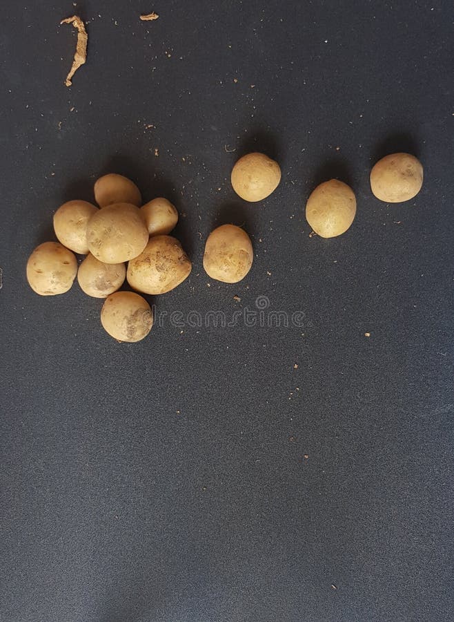 Small Potatoes on a Black Table Stock Photo - Image of gourmet, potato ...