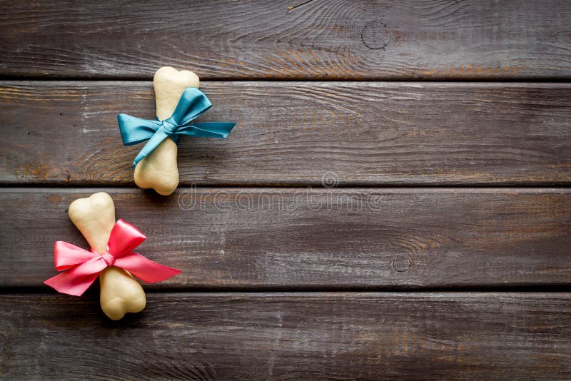 Small Present for Dogs. Chewing Bones with Bow on Dark Wooden ...