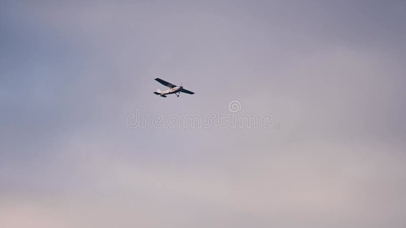 Small Propeller Plane Flying Low through a Cloudy Sky at Sunset Stock ...