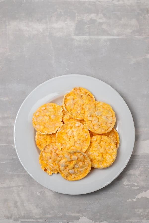 Small Puffed Corn Cakes on Small White Plate Stock Photo - Image of ...