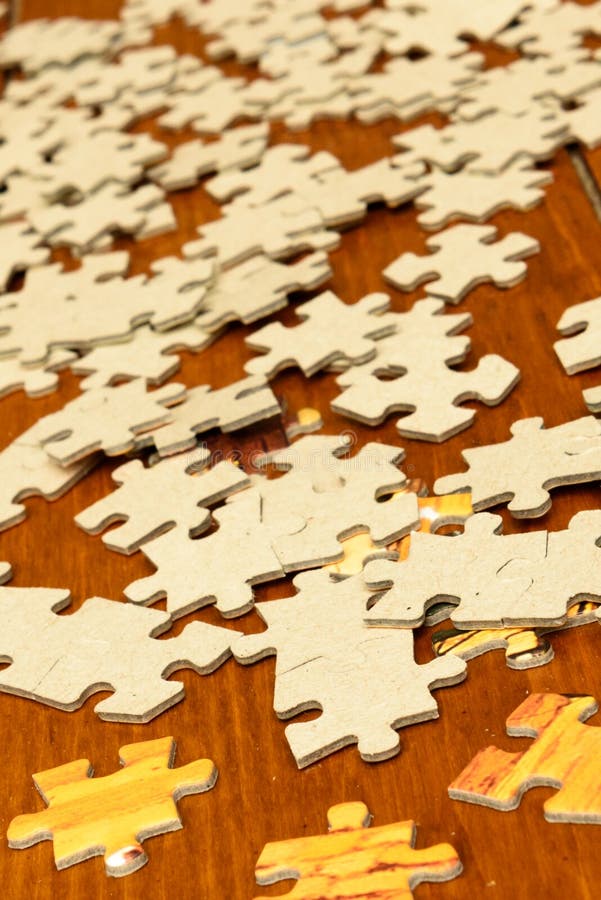 Small Puzzle Pieces are Strewn Across a Table Top. Stock Photo - Image ...