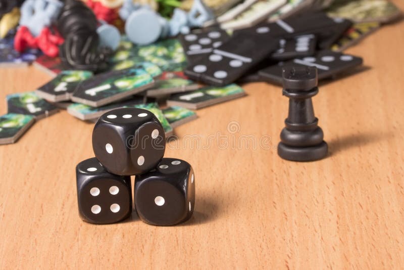 Small Pyramid of Black Cubes of Dice on the Background of Scattered ...