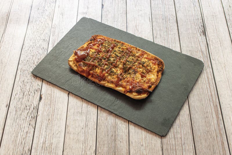 A Small Rectangular Barbecue Pizza on a Black Slate Tray Stock Image ...
