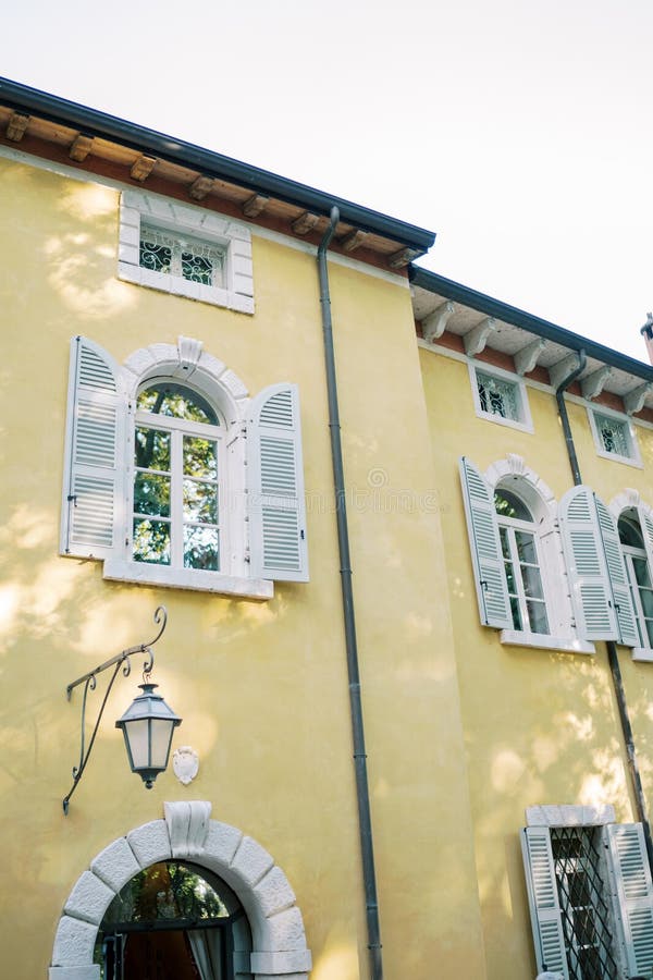 Small Rectangular Windows Under the Roof on the Yellow Facade of an Old ...