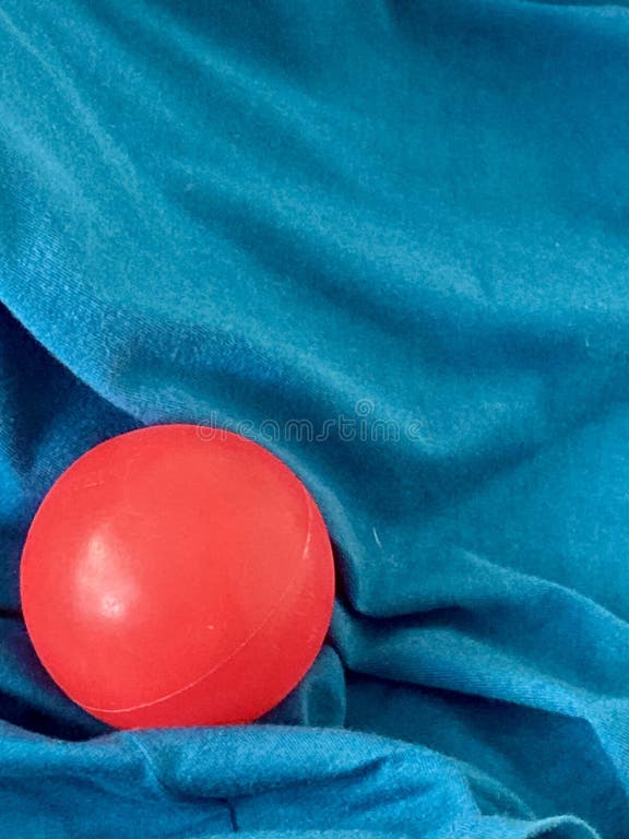 Small Red Ball on a Blue Cloth Background Stock Photo - Image of book ...