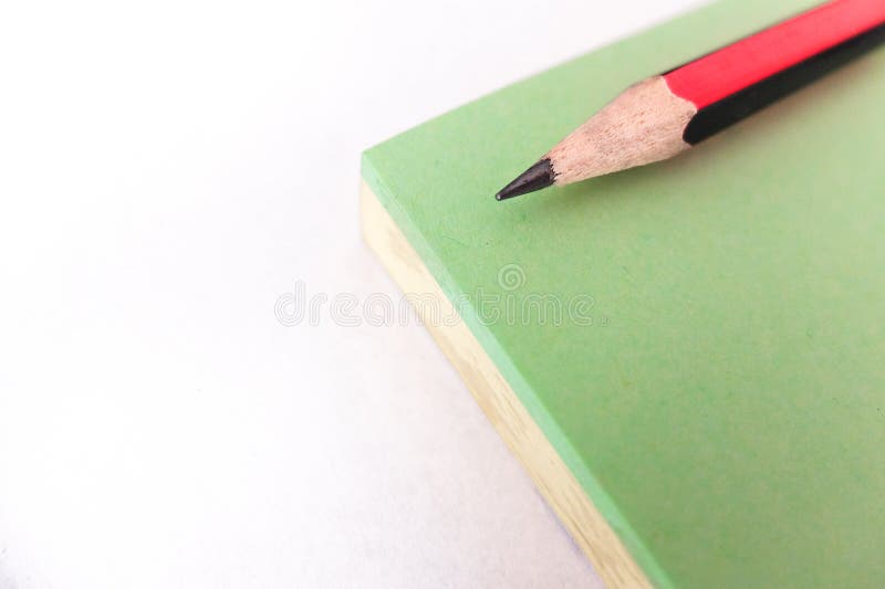 Small Red and Black Pencil, Sharp at Both Ends, on a Green and Yellow ...