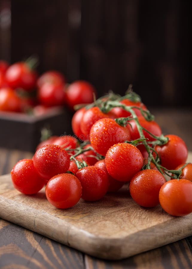 Small Red Cherry Tomatoes On Rustic Background. Cherry Tomatoes On The ...