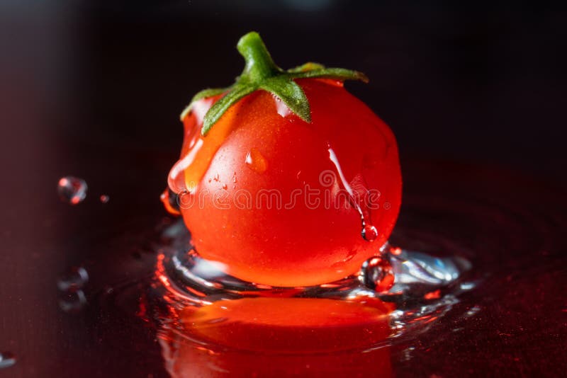Small Red Cherry Tomatoes, in Water with Falling Drops, Frozen Motion ...