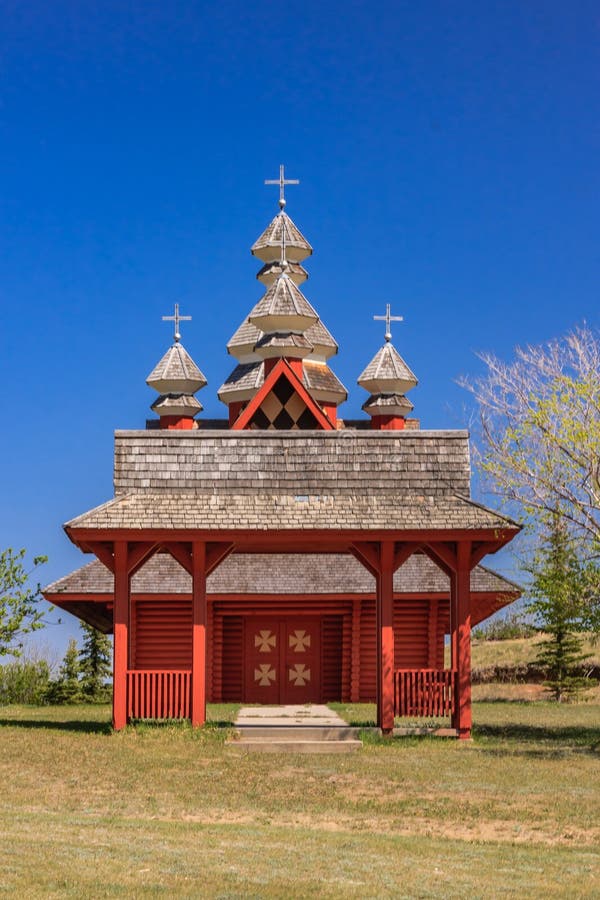 A Small Red Church with a Blue Sky in the Background Stock Photo ...