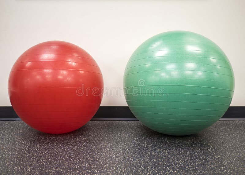 Small Red Exercise Ball beside a Medium Size Swiss Ball in the Gym ...