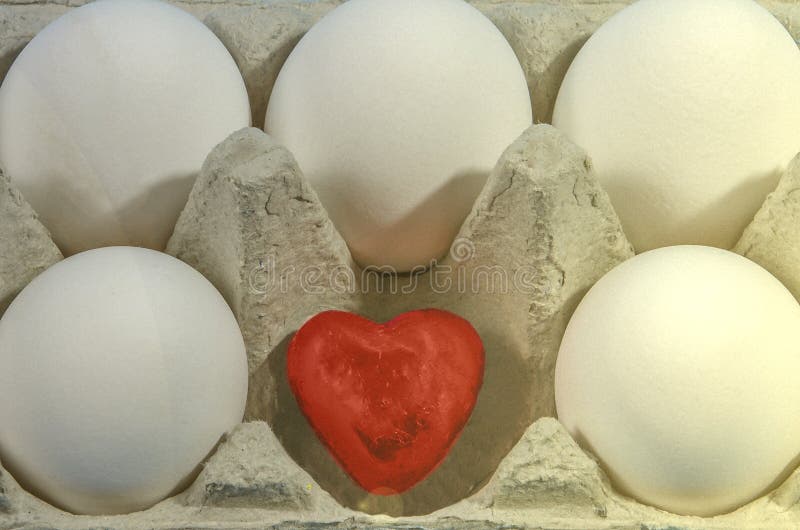 Small Red Heart in a White Egg Shell on a Blue Background. Stock Photo ...