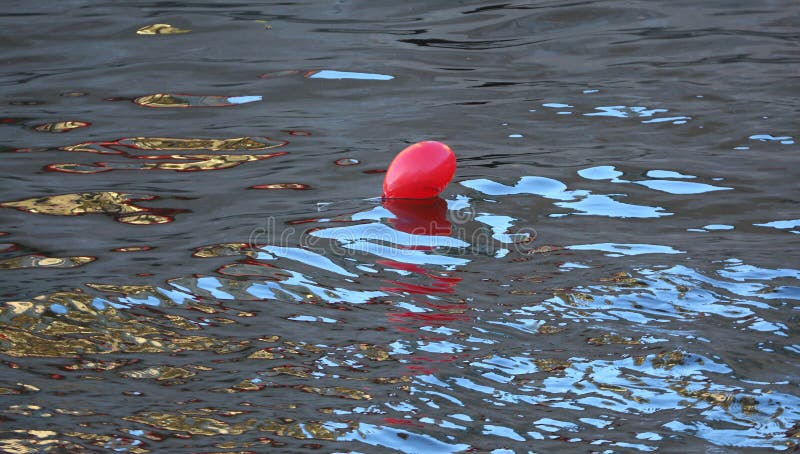 Small Red Inflatable Balloon Floats on the Waves among the Sun Glare ...
