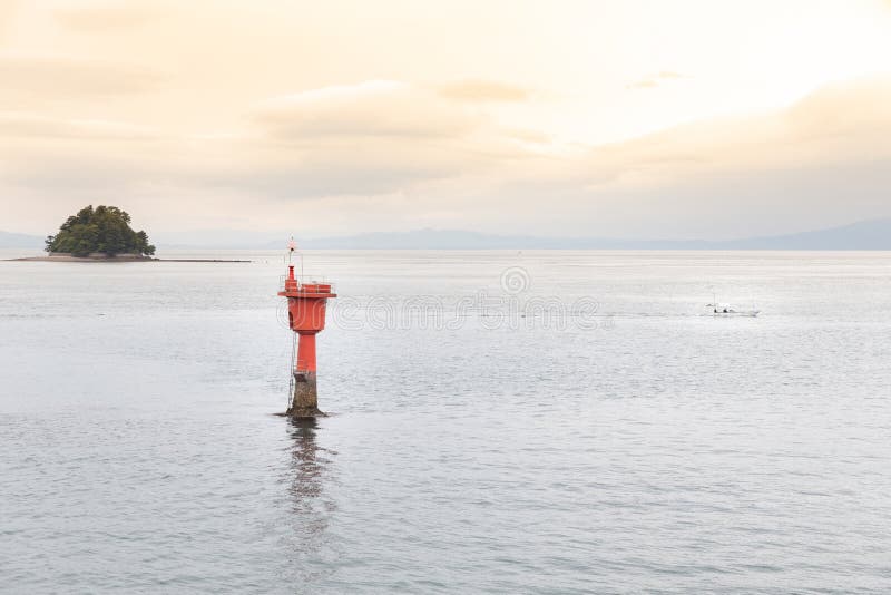 Small Red Lighthouse in the Middle of the Sea or Ocean Stock Photo ...