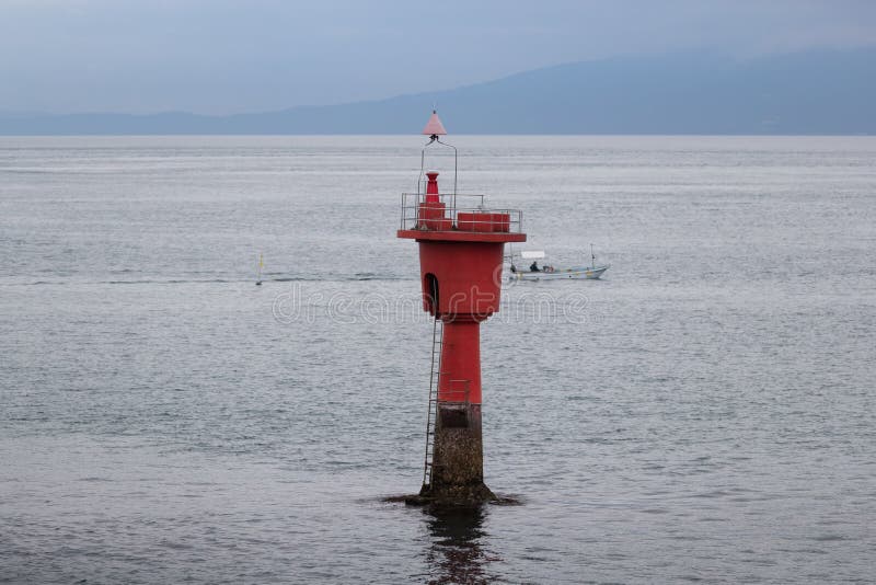 Small Red Lighthouse in the Middle of the Sea or Ocean Stock Photo ...