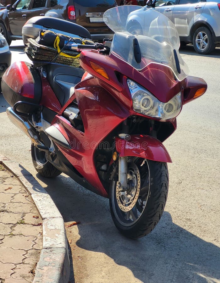 A Small Red Motorcycle is Parked Near the Sidewalk on a Hot Day. Stock ...