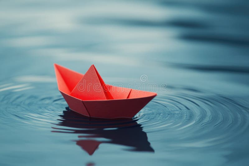 A Small Red Paper Boat Floats Peacefully on the Surface of the Water ...