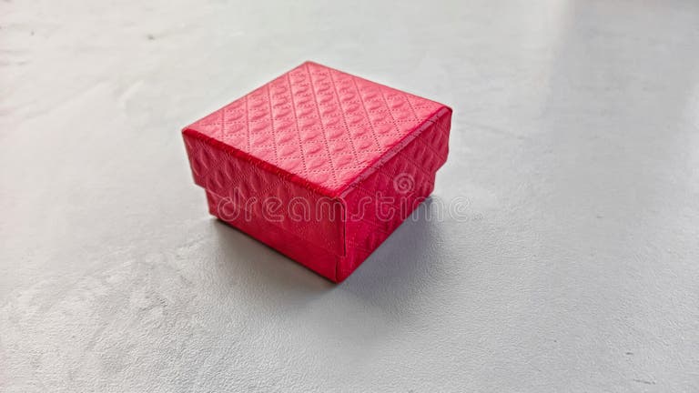 Small Red Textured Gift Box on a Smooth Gray Surface Stock Image ...