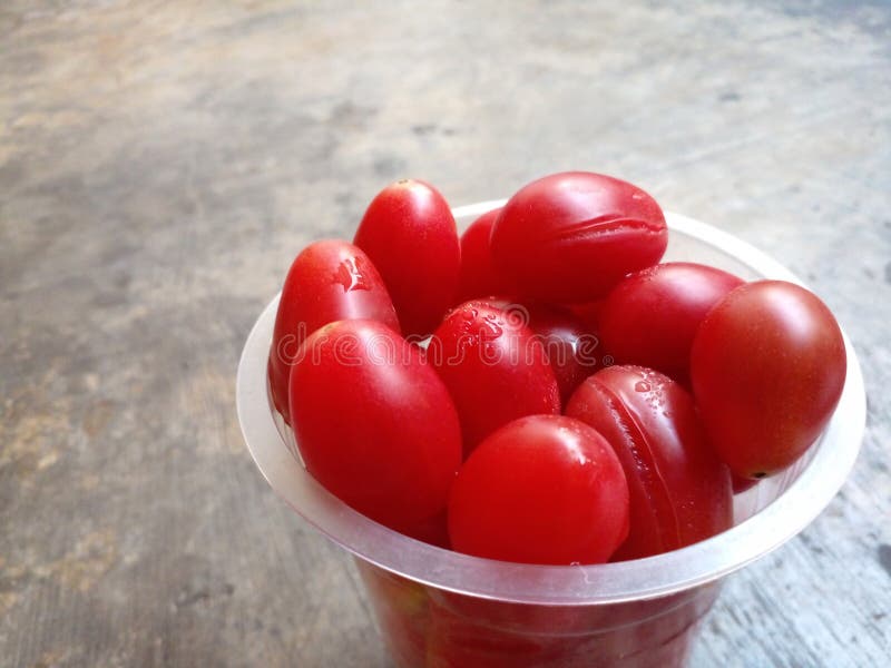 Small Red Tomatoes Placed in a Plastic Cup. Fresh Red Tomatoes Stock ...
