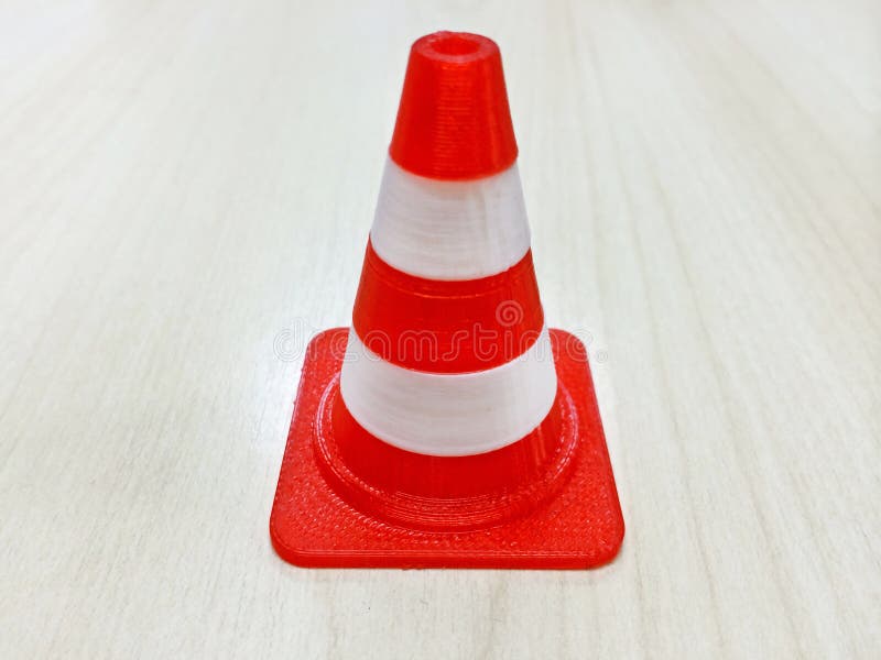 Small Red and White Cone Model Made by 3D Printer on Wooden Table with ...