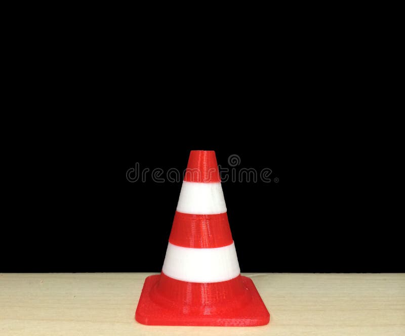 Small Red and White Cone Model Made by 3D Printer on Wooden Table with ...