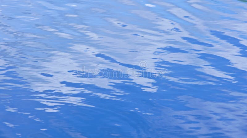 Small Ripples on the Surface of the Lake with a Reflection of the Blue ...