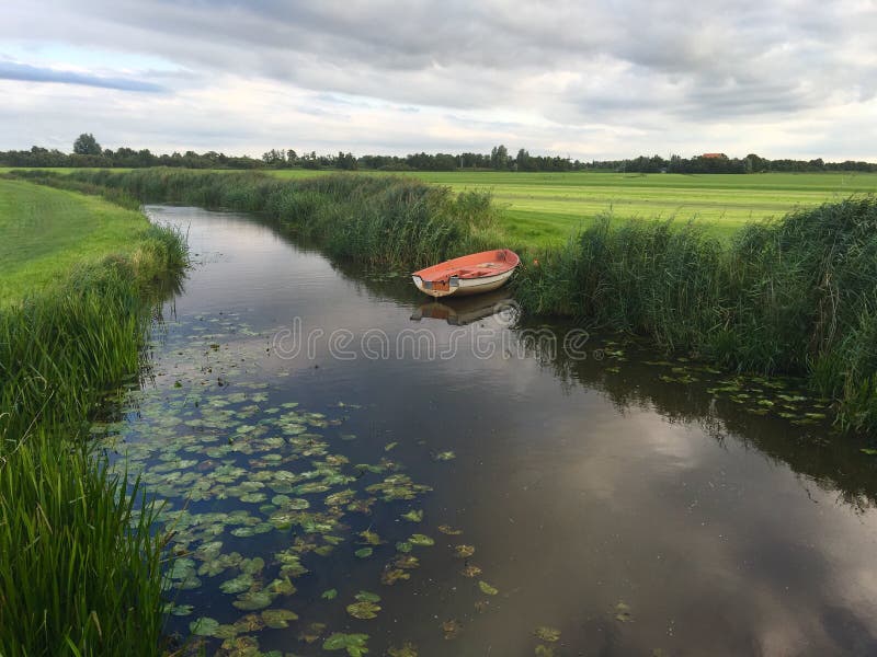 Small river with a boat stock image. Image of netherlands - 75818713