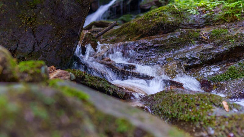 Small River Cascade Flowing Down from the Mossy Rocks Stock Photo ...