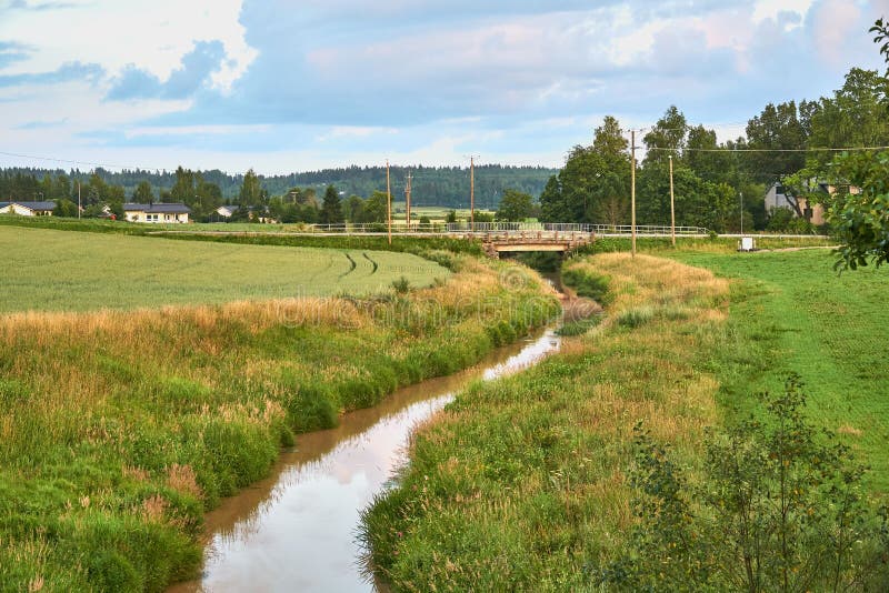 Small River Flowing Green Fields Under Cloudy Sky Stock Photos - Free ...