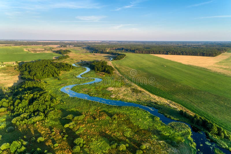 A Small River Flowing through Meadows and Agricultural Fields. Aerial ...