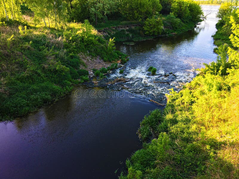 A Small River Flows into a Large River Stock Photo - Image of grass ...